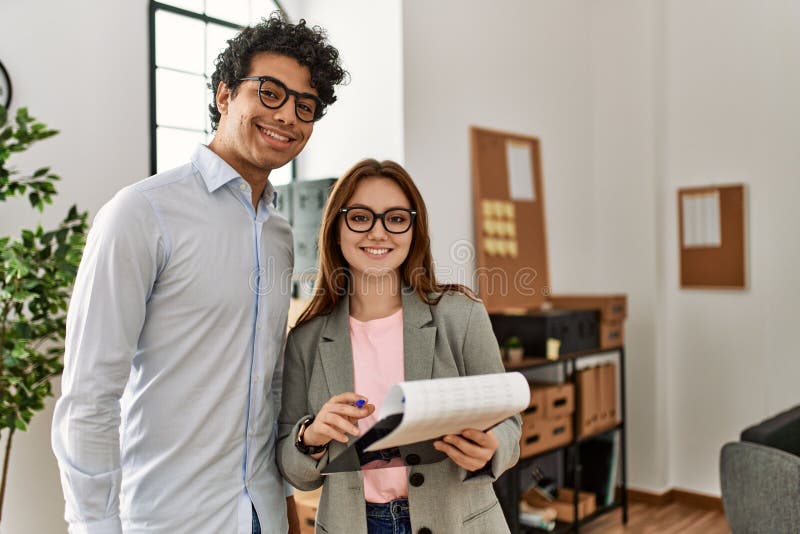 Two Business Workers Smiling Happy Holding Clipboard Standing at the ...
