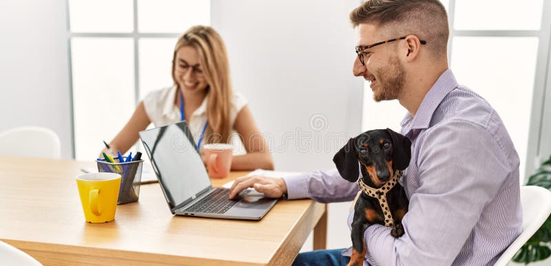 Two Business Workers Smiling Happy Working with Dog at the Office Stock ...