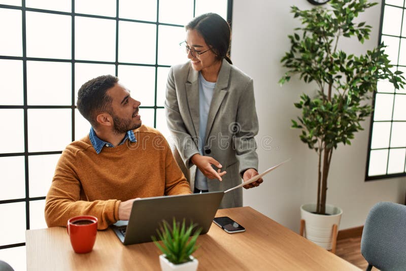 Two Business Workers Smiling Happy Working Sitting on Desk at the ...