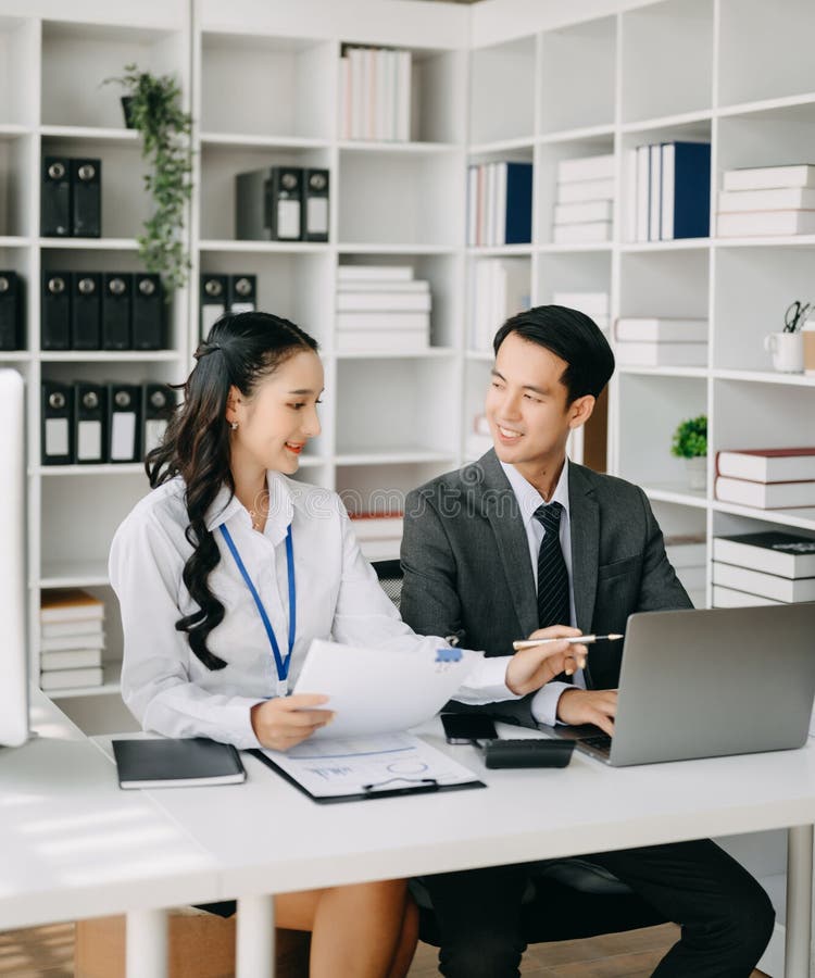 Two Business Workers Talking on the Smartphone and Using Laptop at the ...