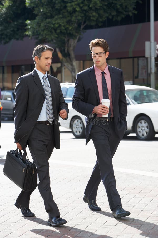 Two Businessman Chatting Whilst Crossing Street Stock Photo - Image of ...