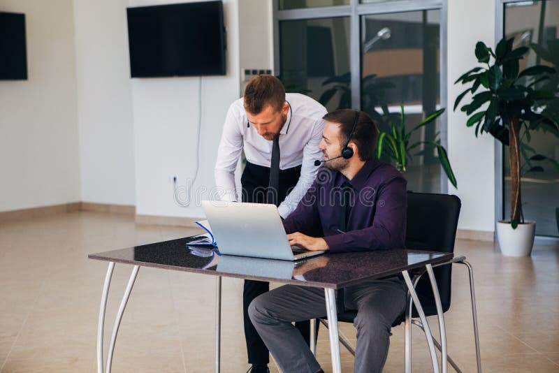 Two Businessmen in a Business Meeting Discussing Graphics Stock Photo ...