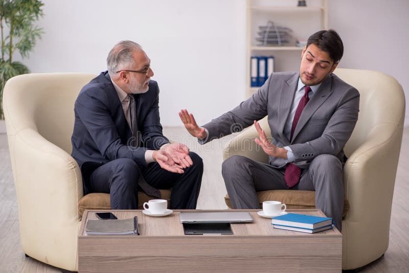 Two Businessmen Discussing Project at Workplace Stock Photo - Image of ...