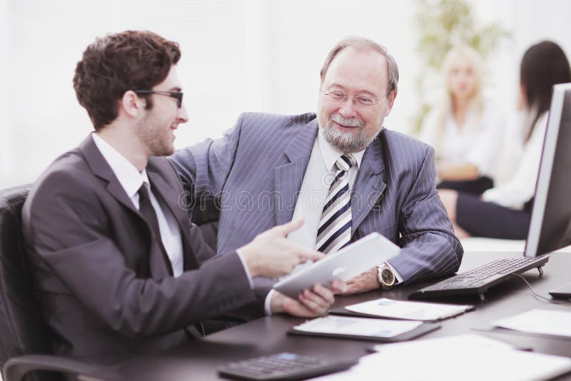 Two Businessmen Discussing Work Issues Sitting at Their Desk Stock ...