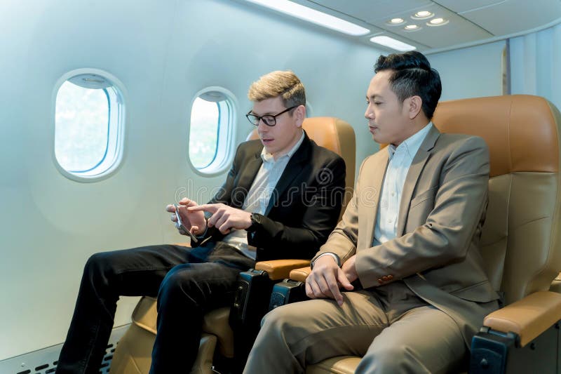Two Businessmen in Formal Suits Analyzing Information on a Mobile Phone ...