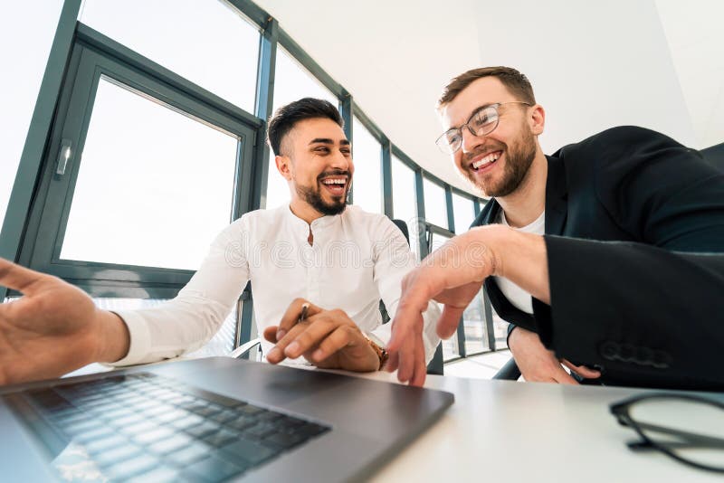 Two Businessmen Laugh while Working at the Lapto. Stock Image - Image ...