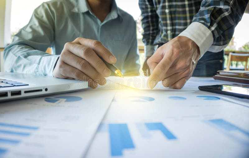 Two Businessmen Looking at Report and Having a Discussion in Off Stock ...