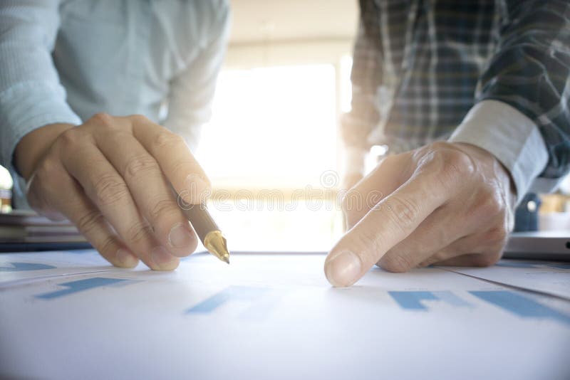 Two Businessmen Looking at Report and Having a Discussion in Off Stock ...