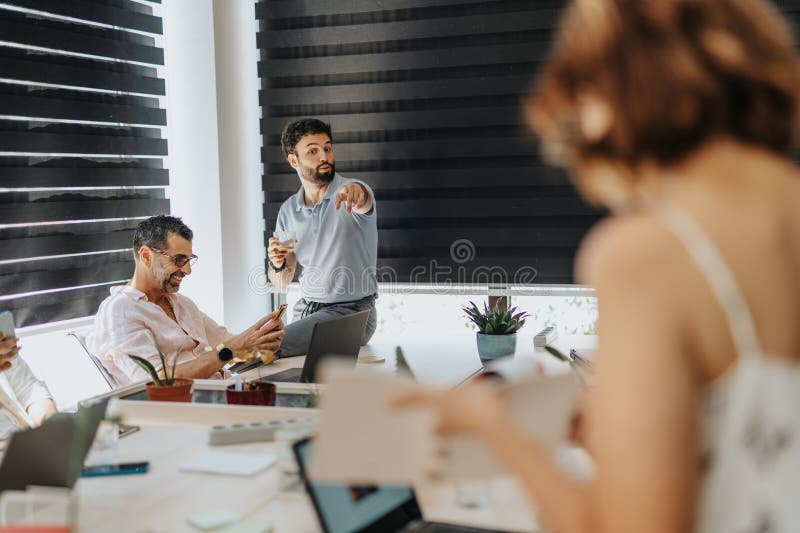 Young and Elderly Businessmen Having Fun during Break in the Office ...