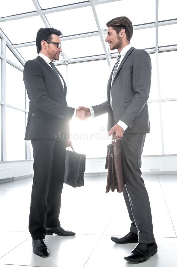 Two Businessmen Shaking Hands in the Lobby of the Office Stock Photo ...