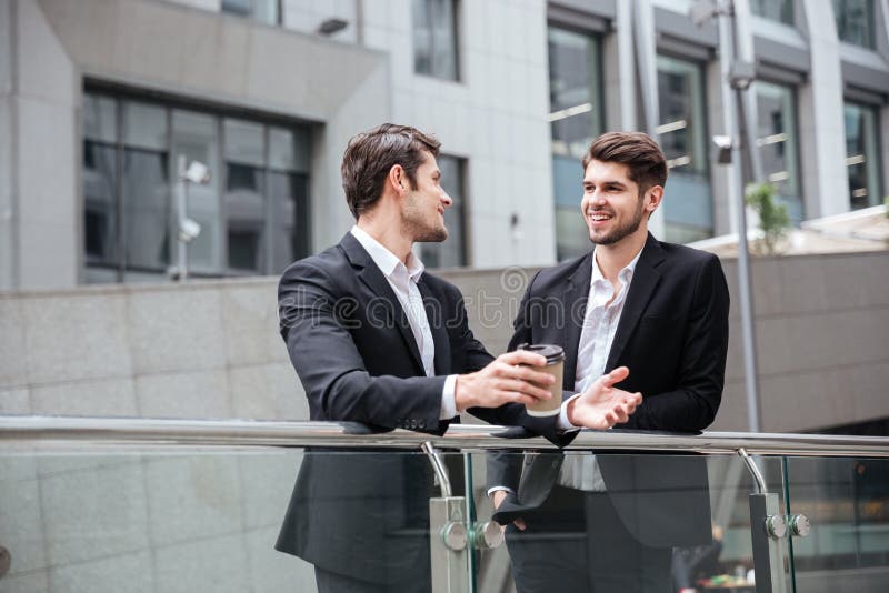 Two Businessmen Talking and Drinking Coffee in the City Stock Photo ...