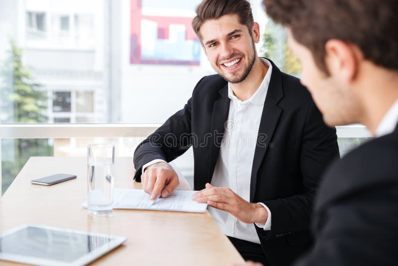 Two Businessmen Talking and Working with Documents in Office Stock ...