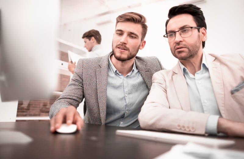 Two Businessmen Use a Computer To Get New Information Stock Photo ...