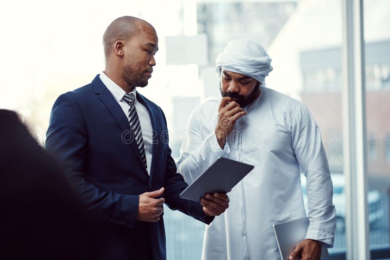 Success Happens when Two Experts Get Together. Two Businessmen Using a ...