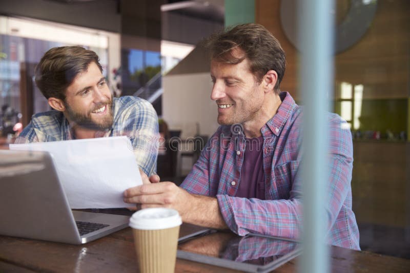 Two Businessmen Working on Laptop in Coffee Shop Stock Image - Image of ...