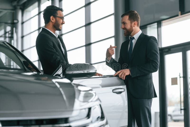 Two Businessmen are Working Together in the Car Showroom Stock Image ...