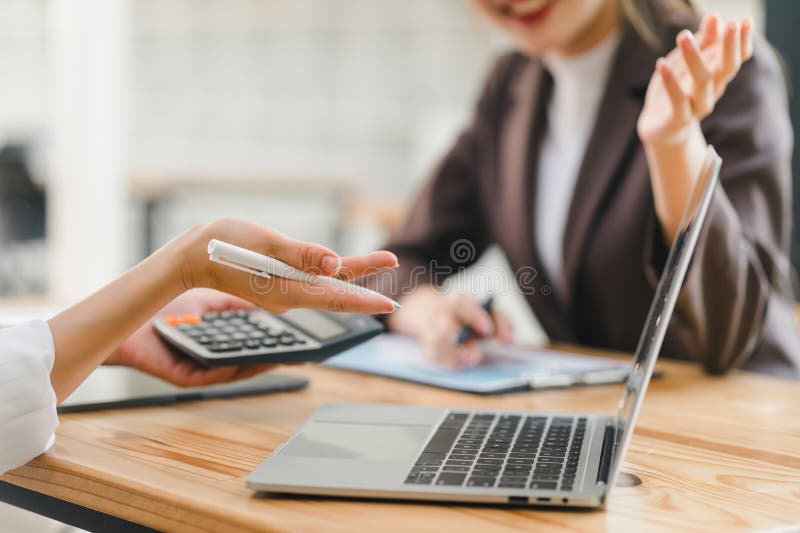 Two Businesspeople or an Accountant Team are Analyzing Data Charts ...