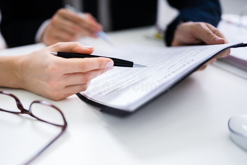 Two Businesspeople Analyzing Document Stock Image - Image of document ...