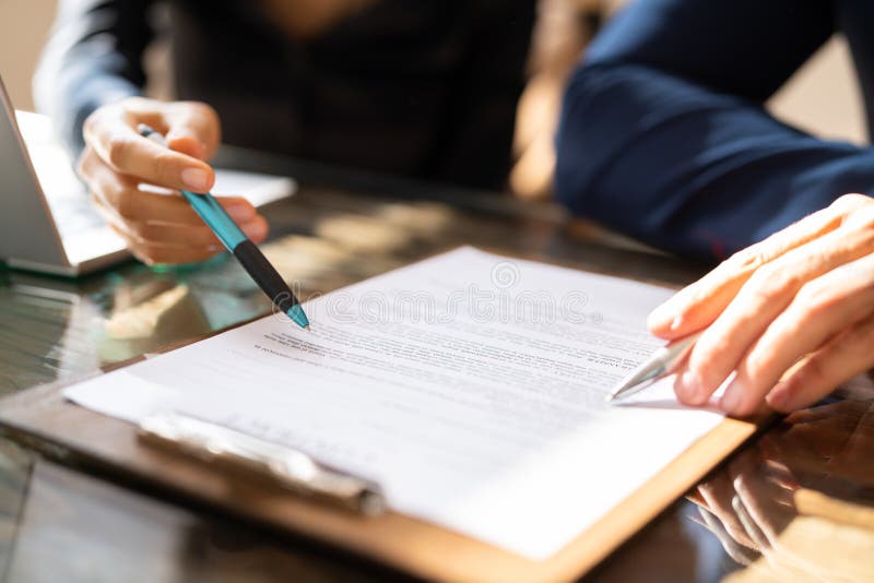 Two Businesspeople Analyzing Document Stock Image - Image of handing ...