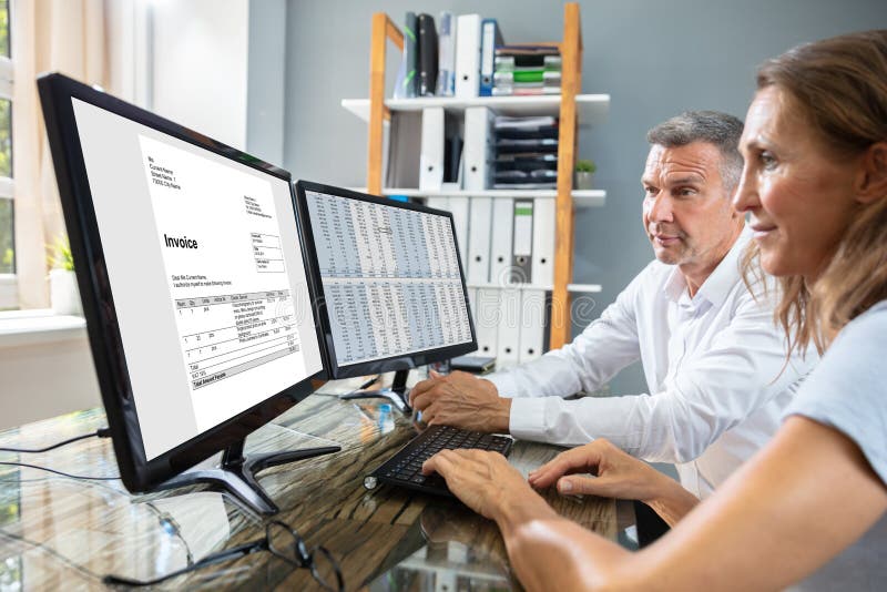 Two Businesspeople Checking Invoice on Computer Stock Image - Image of ...