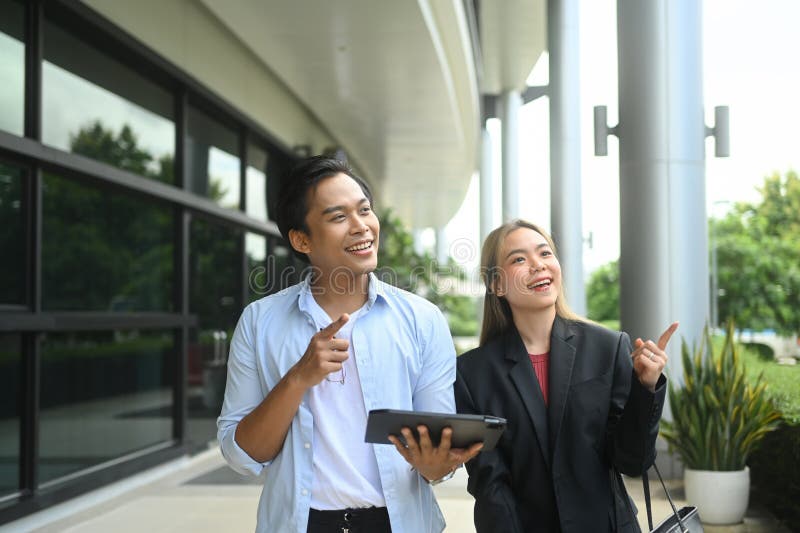 Two Businesspeople with Friendly Conversation Walking Together Outside ...
