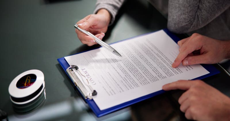 Two Businesspeople Hand Analyzing Document Over Glass Stock Photo ...