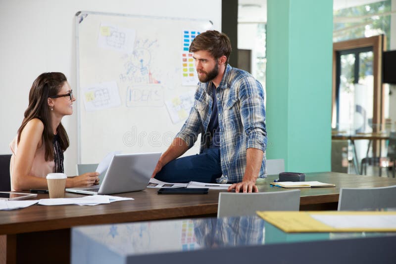 Two Businesspeople Working on Laptop in Office Together Stock Photo ...