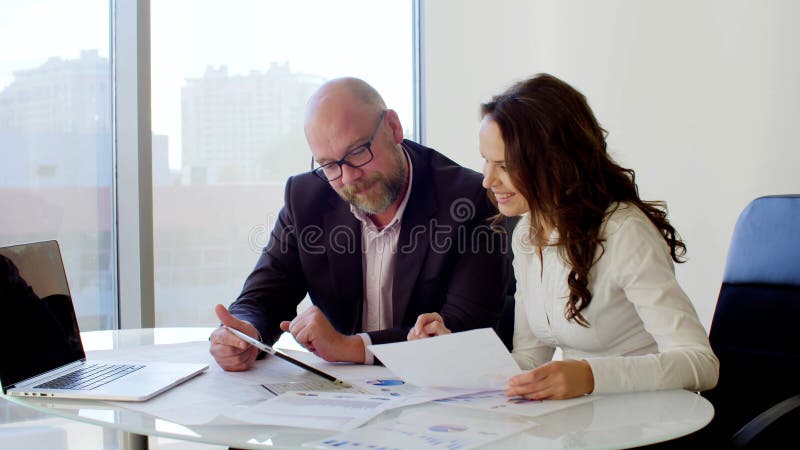 Two Businesspeople Working with Tablet Pc and Documents in Office Stock ...