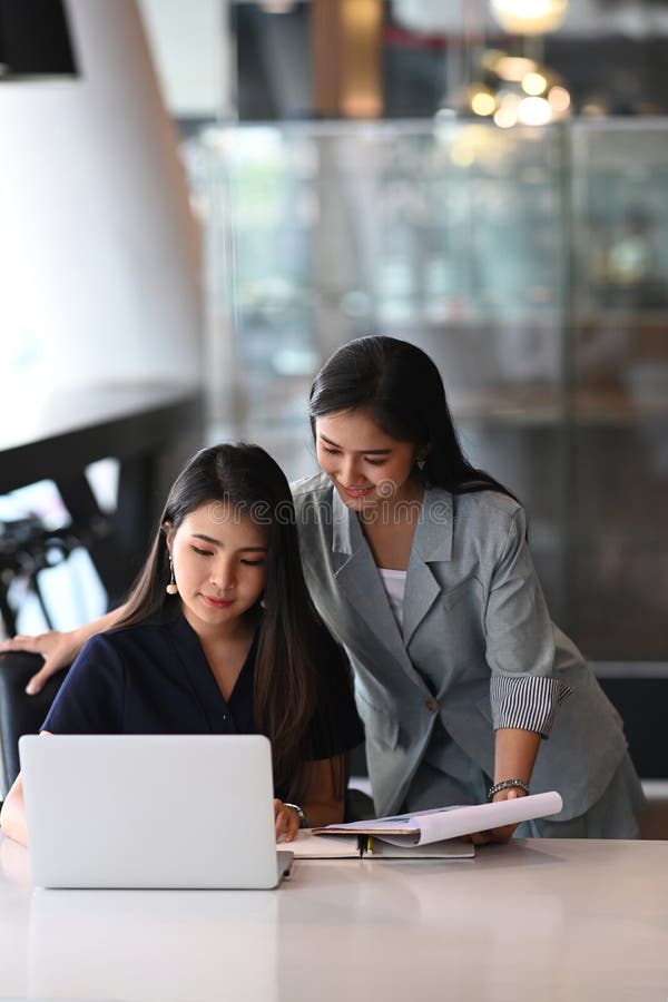 Two Businesswoman Colleagues Working Together in Office. Stock Image ...
