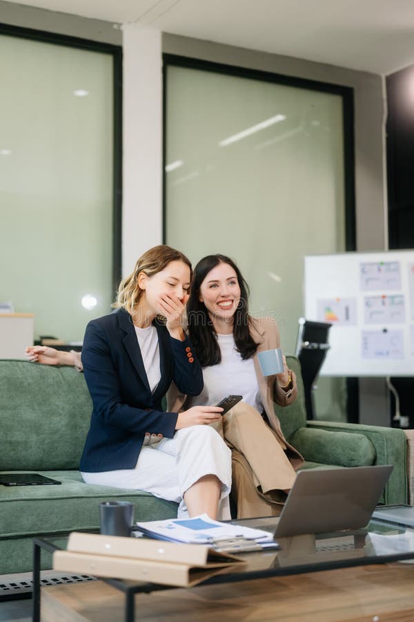 Two Businesswomen Collaborate Using a Tablet in a Stylish Office ...