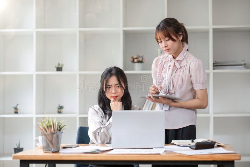 Two Businesswomen Colleagues Working Together Look at Laptop Screen ...