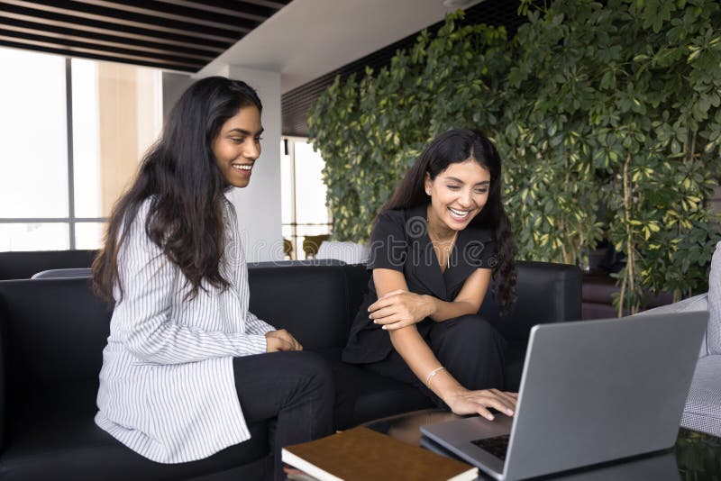 Two Joyful Businesswomen Take Part in Productive Teamwork Using Laptop ...