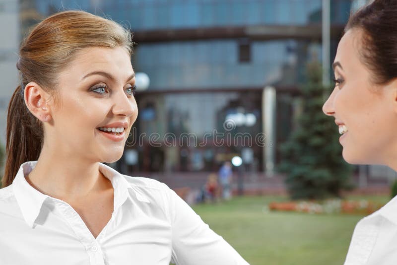 Two Businesswomen Having a Friendly Conversation Stock Image - Image of ...