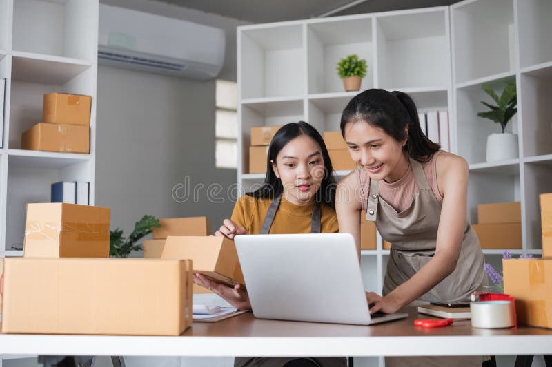 Two Businesswomen Managing Online Orders with Laptop in Office. Concept ...