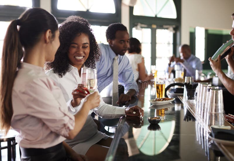 Two Businesswomen Meeting for after Works Drinks in Bar Stock Photo ...