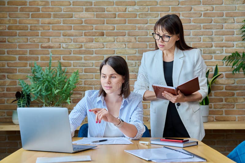 Two Businesswomen Talking and Discussing in Office Stock Image - Image ...