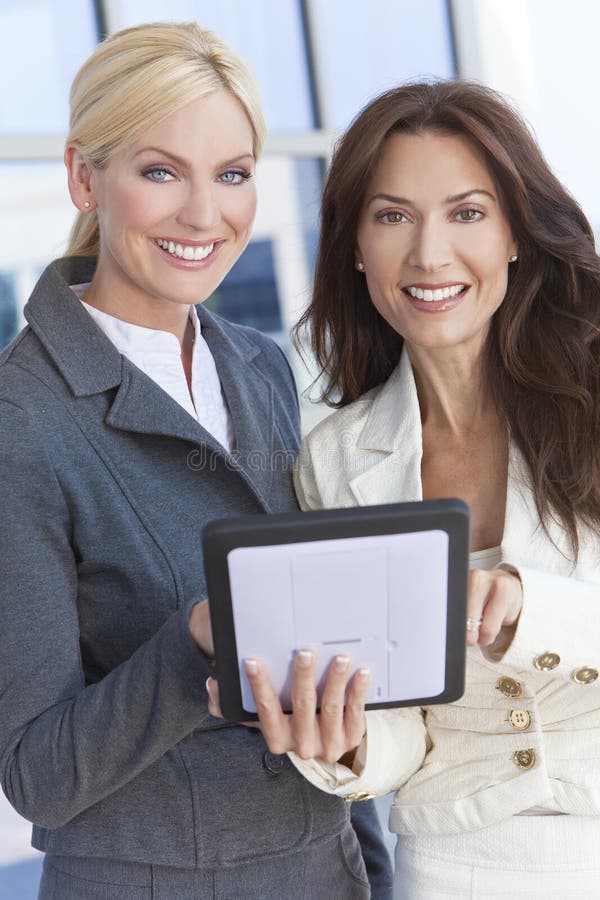 Two Businesswomen or Women Using Tablet Computer Stock Photo - Image of ...