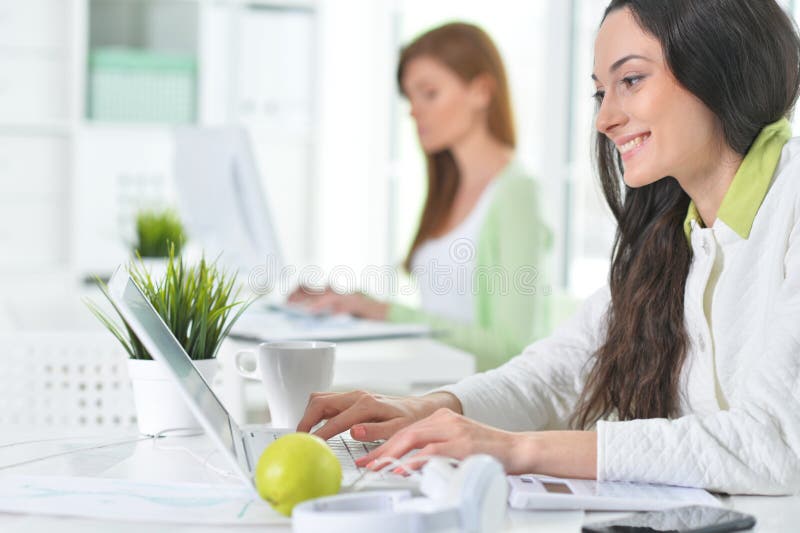 Two Businesswomen Working at Modern Office during Lunch Time Stock ...