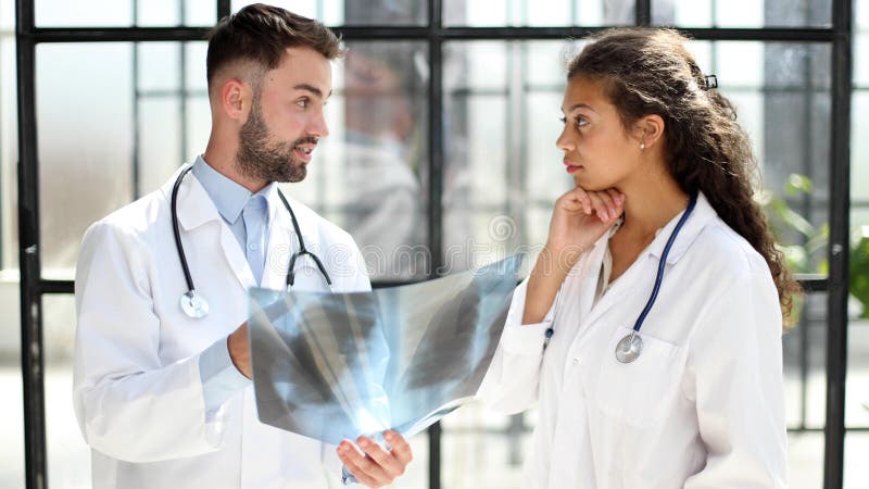 Two Busy Doctors Working with Papers and Xray Images Stock Image ...