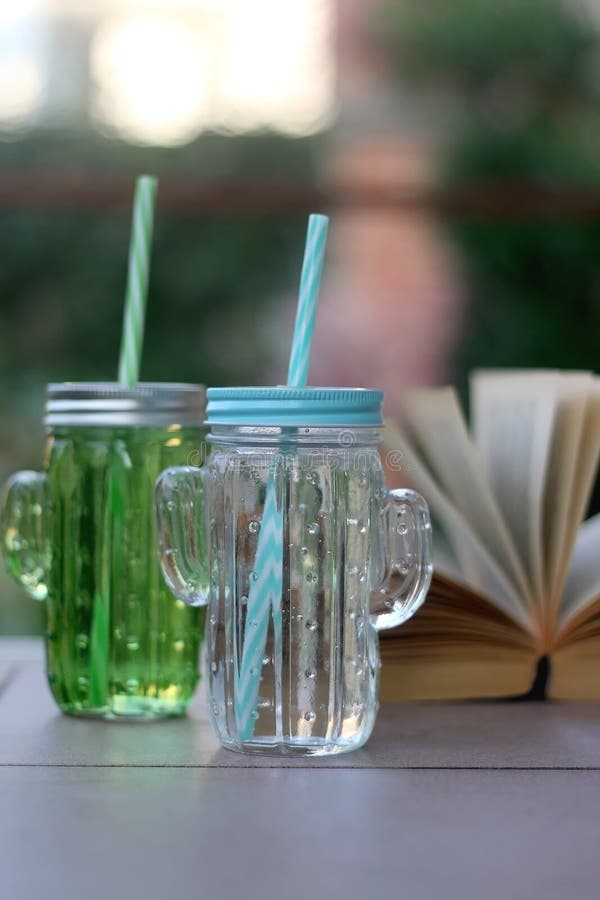 Refreshing Drink and Book stock image. Image of garden - 189105599