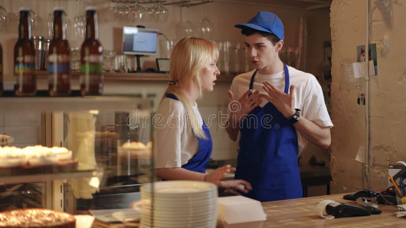 Two Cafe Workers are Loudly Arguing and Squabbling, while Standing at ...