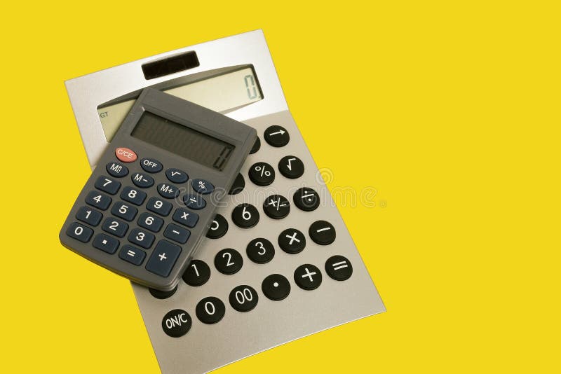 Two Calculators on a Yellow Surface. Office Accessories. School Stock ...