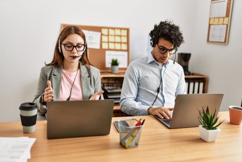 Two Call Center Agents Concentrated Having Video Call Using Laptop at ...