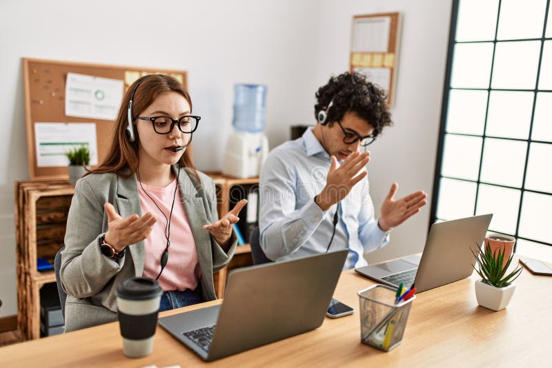 Two Call Center Agents Concentrated Having Video Call Using Laptop at ...