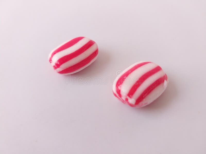 Two Candies with White and Pink Pattern on White Background Stock Image ...
