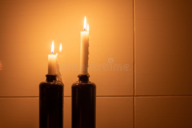 Two Candles in the Ceramic Bottles Next To the Wall Stock Photo - Image ...