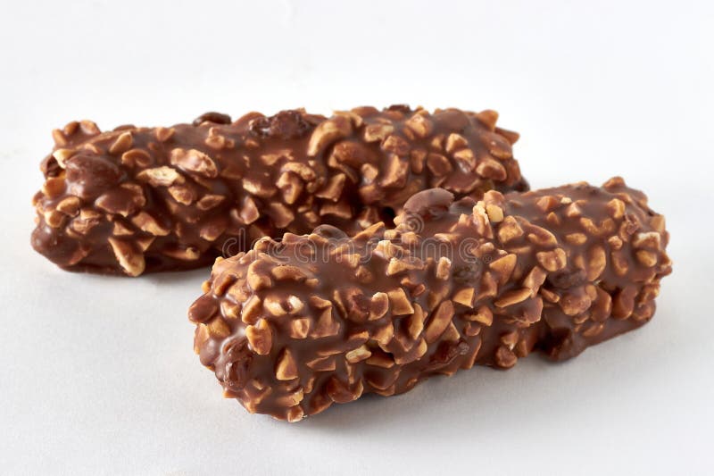 Two Candy Bars Covered with Peanuts and Chocolate on a White Table ...