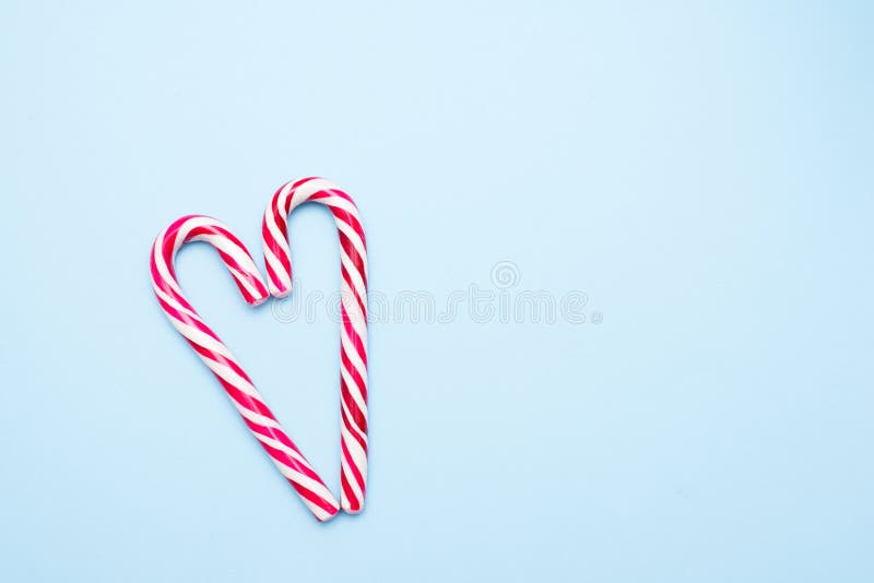 Two Candy Canes in Heart Shape on Blue Background. Copy Space Stock ...