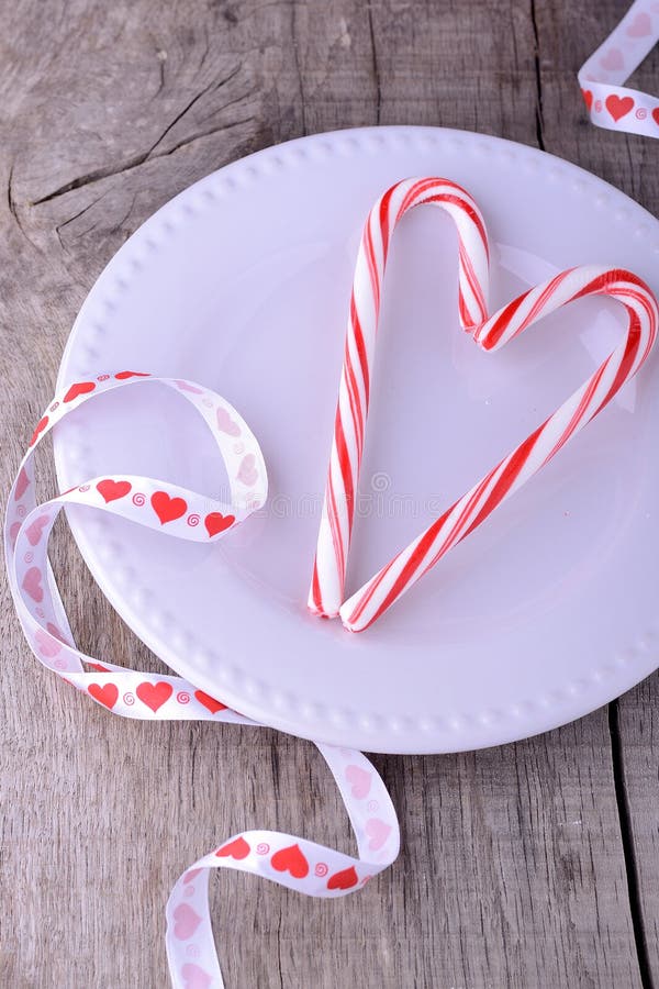 Two Candy Canes in Heart Shape with Red Bow Stock Photo - Image of ...