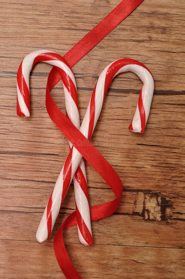 Two Candy Canes with a Red Ribbon Stock Photo - Image of food, festive ...